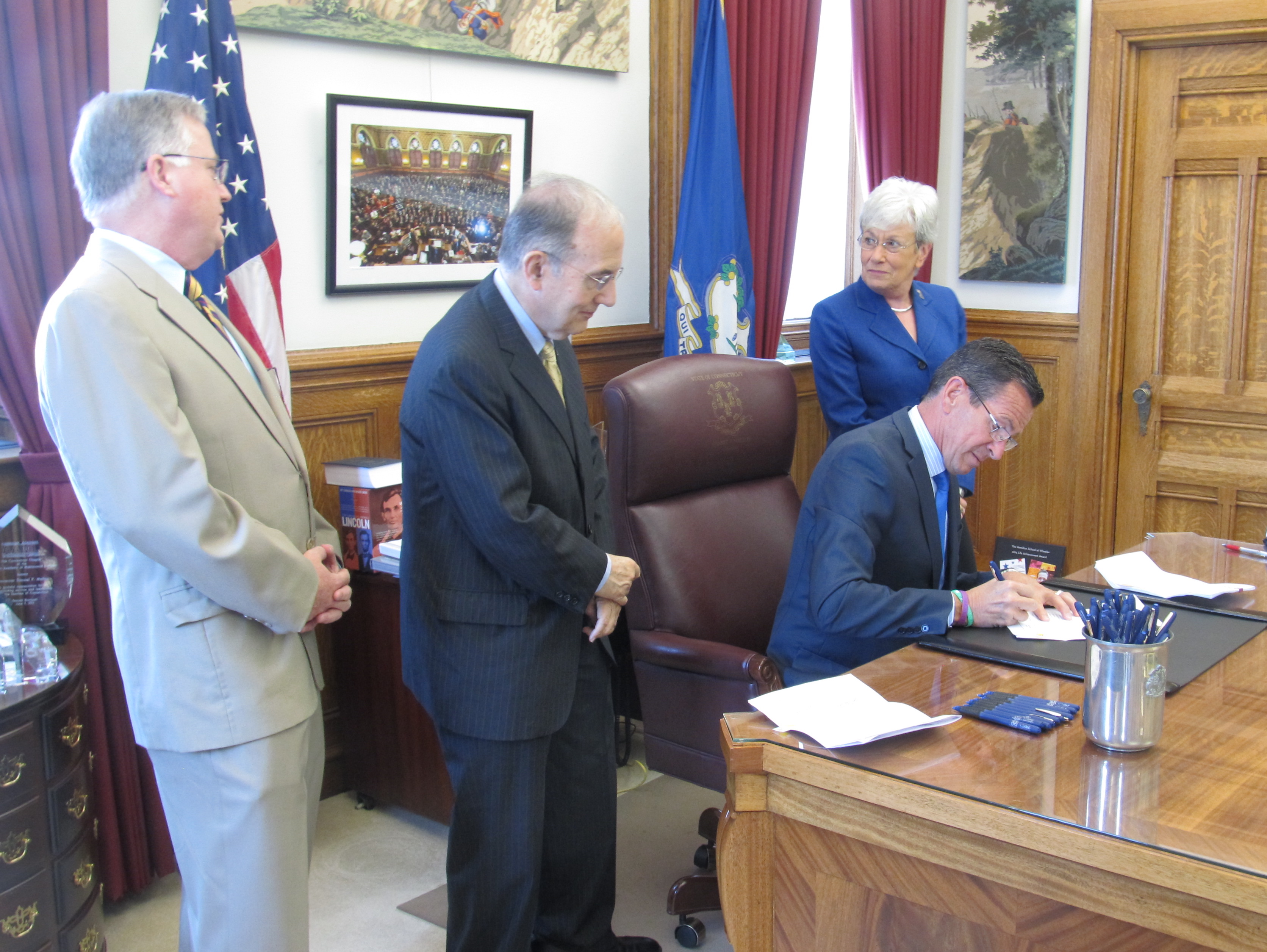Malloy signs, then promotes, newly tweaked budget